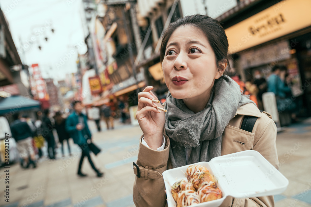 Stock-Foto „Beautiful asian woman eat takoyaki with lovely smile. cute ...