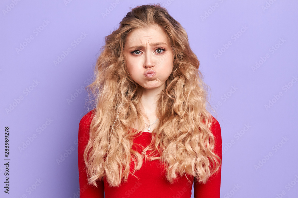 Annoyed irritated funny woman blowing her cheeks, frowning, feeling ...