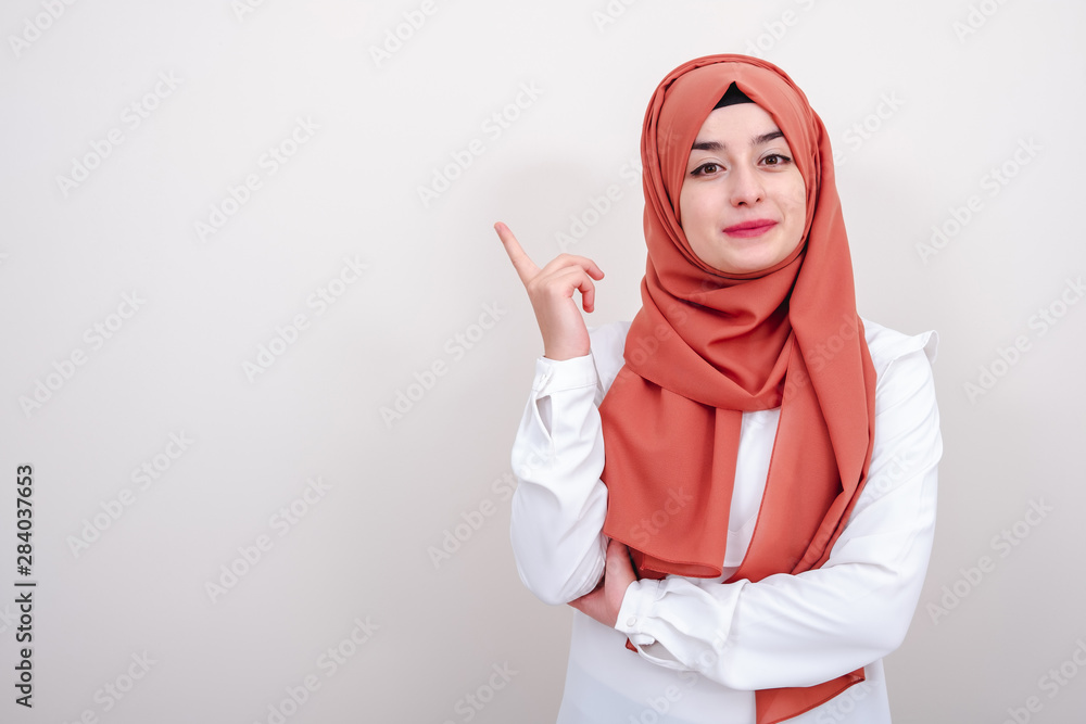 Hijab muslim woman pointing finger to blank copy space area, girl ...