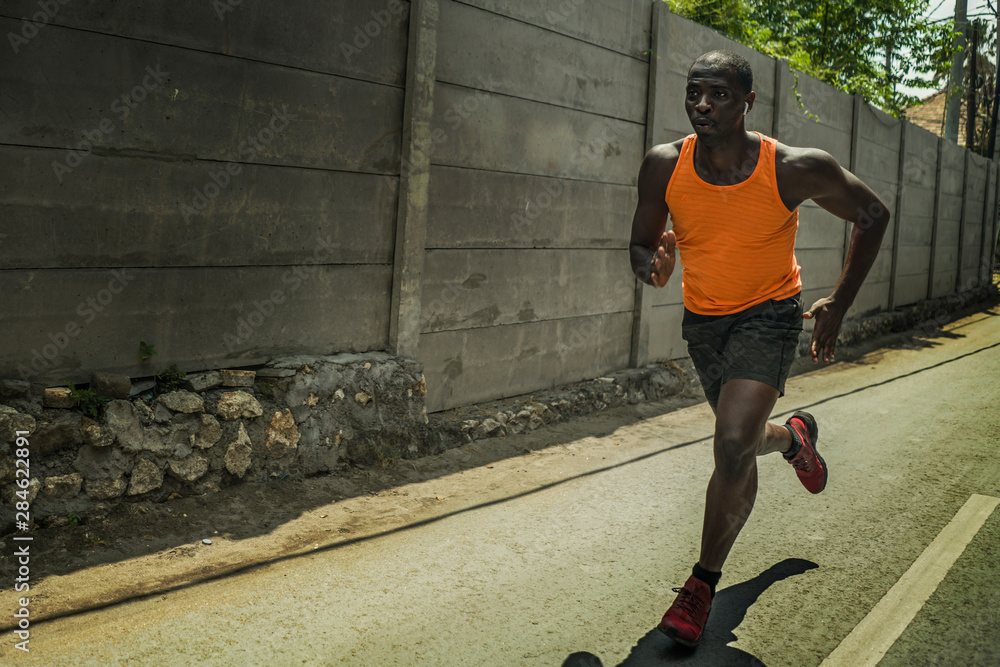 runner lifestyle portrait of young attractive and fit black African ...