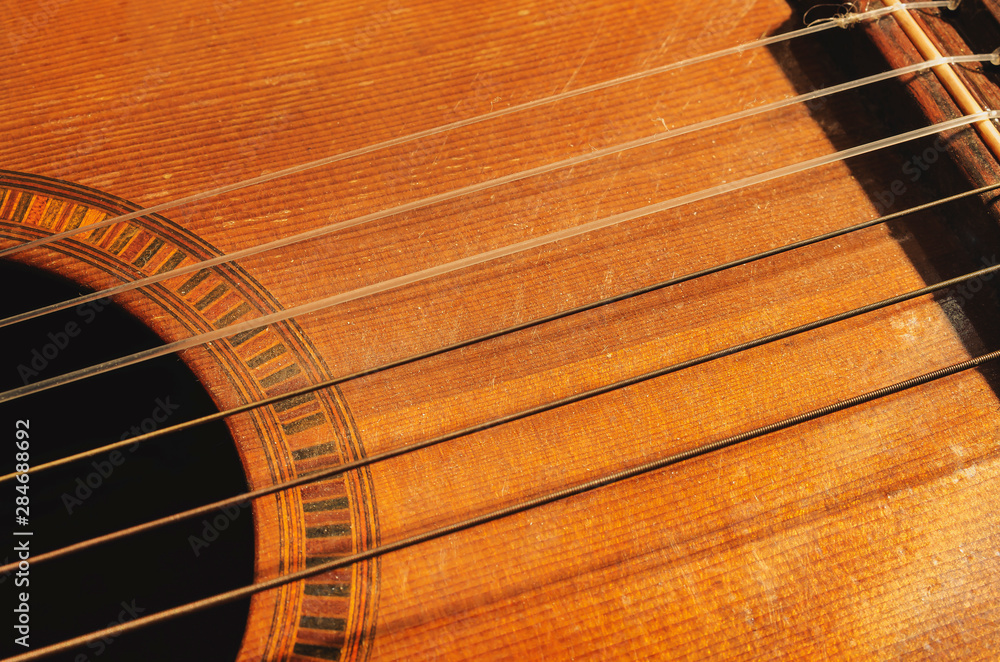 Shapes and lines of an old acoustic guitar, sound hole, part of the ...