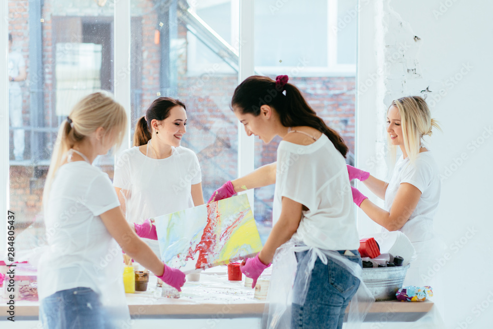 Creative woman painter teach group of four female students creating ...
