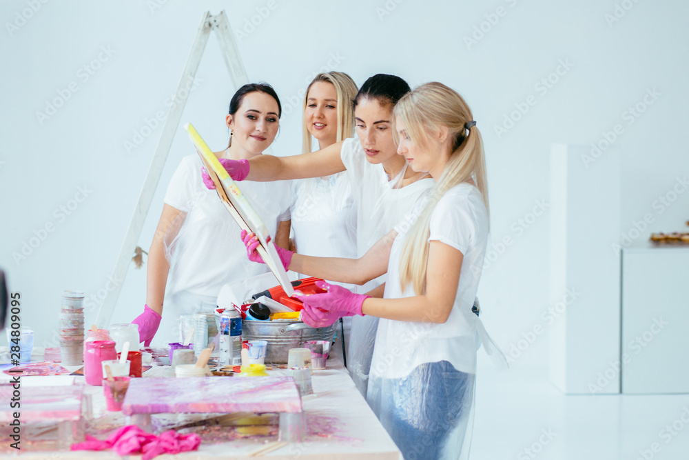 Creative woman painter teach group of four female students creating ...
