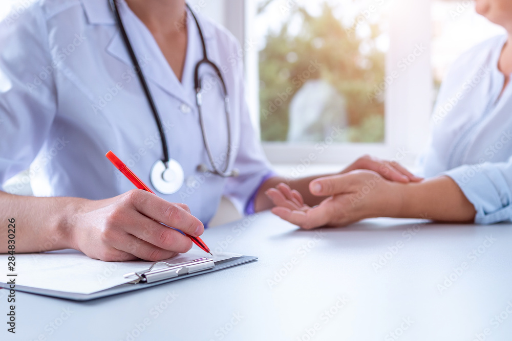 Professional general medical doctor measuring pulse of patient and ...