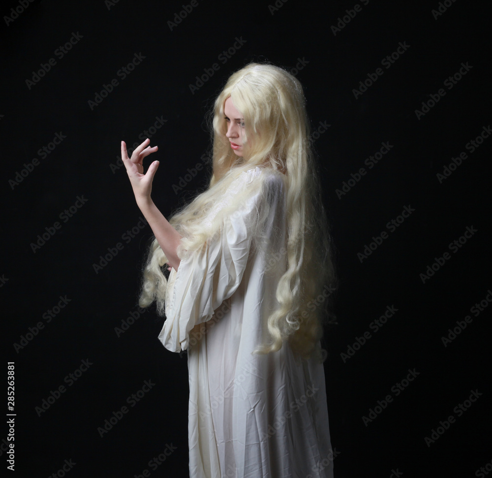 Ghostly portrait of a woman with long blonde hair wearing a white robe ...