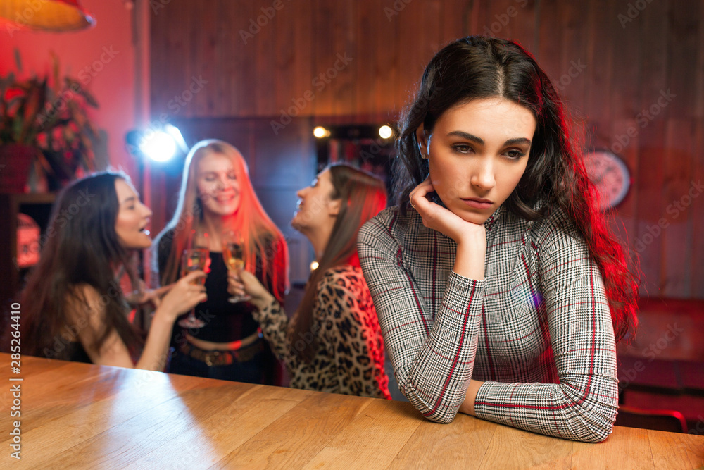 Zdjęcie bez tantiem: Sad bored girl at a party on background of dancing ...