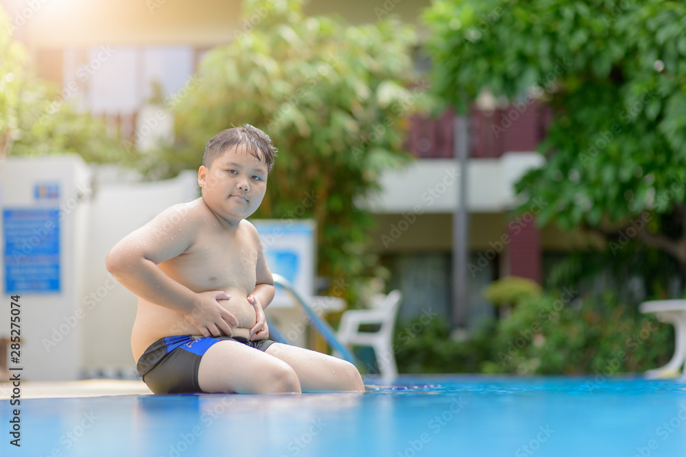 Obese fat boy sit on swimming pool Stock Photo | Adobe Stock