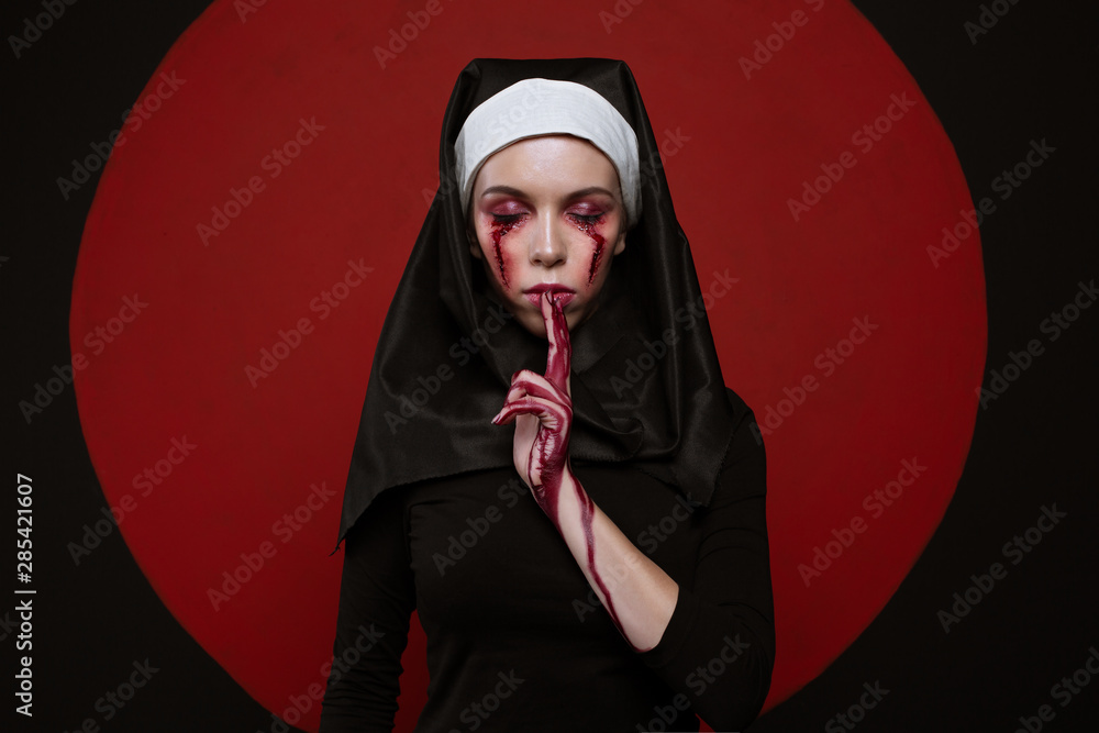 Satanic nun with bloody scar on face. Horror halloween concept. Sister ...