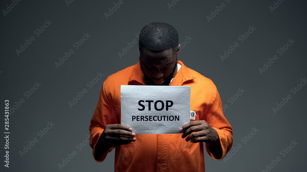 Afro-american prisoner holding stop persecution sign, racial ...