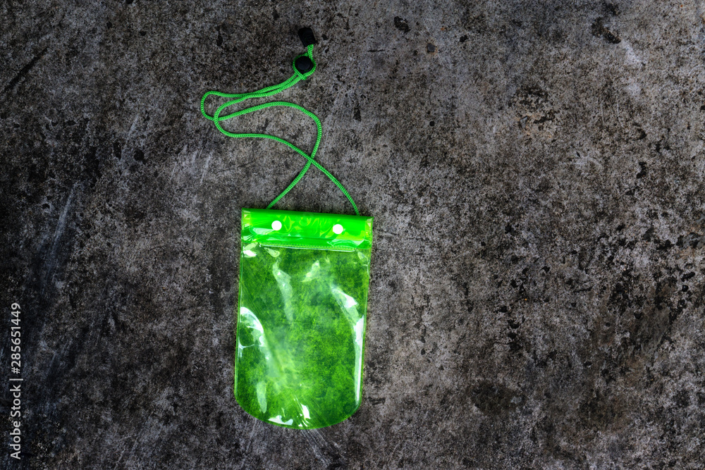 Green waterproof mobile phone case on texture background.PVC zip lock ...