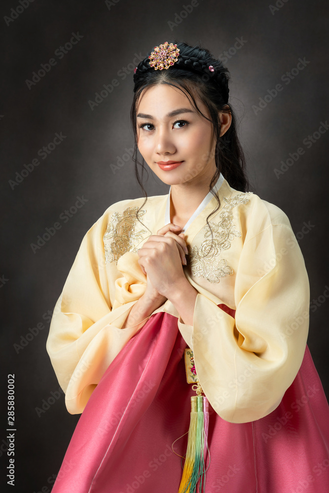 Korean woman wearing traditional korean dress (Hanbok) on black ...
