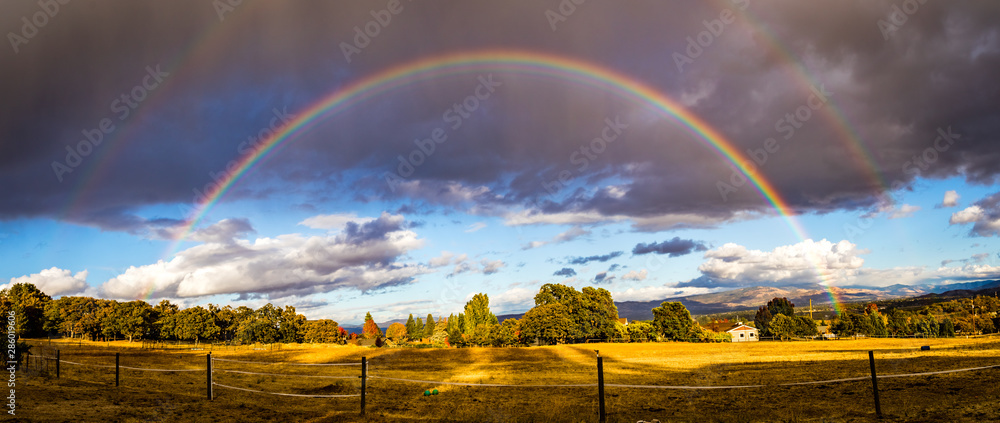 Double rainbow over a dry grass horse pasture in Southern Oregon Stock ...