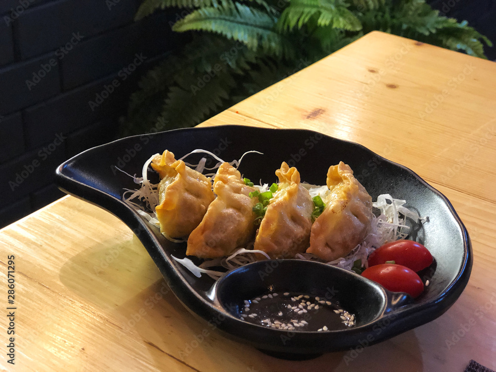 Gyoza dumplings on Black dish,popular japanese food, plate of Japanese ...
