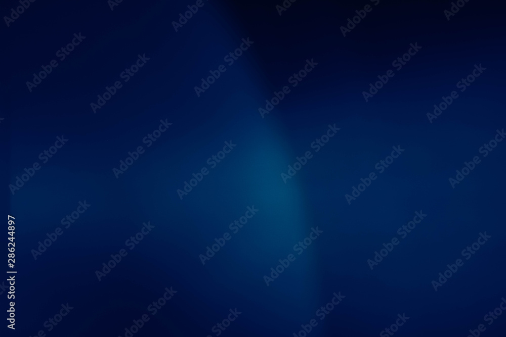 Defocused navy blue abstract art background. Colored lens flare. Blur ...