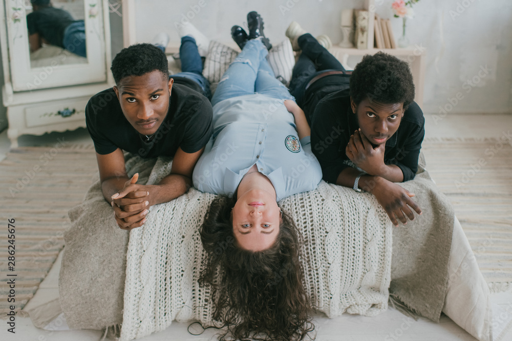 Multicultural love and relationships concept. White woman lying on bed ...