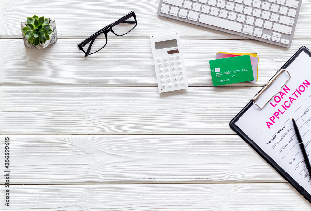 loan application with bank cards and keyboard on white wooden ...