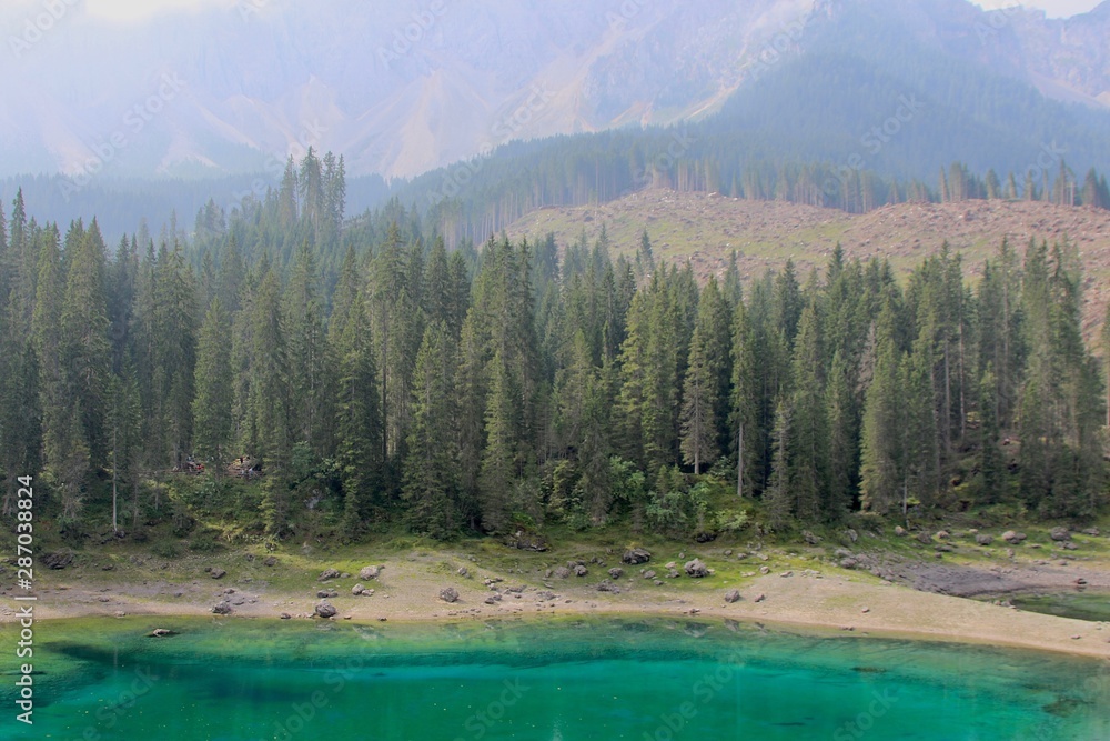 Lake Carezza, the small mountain lake is famous for the dark green ...