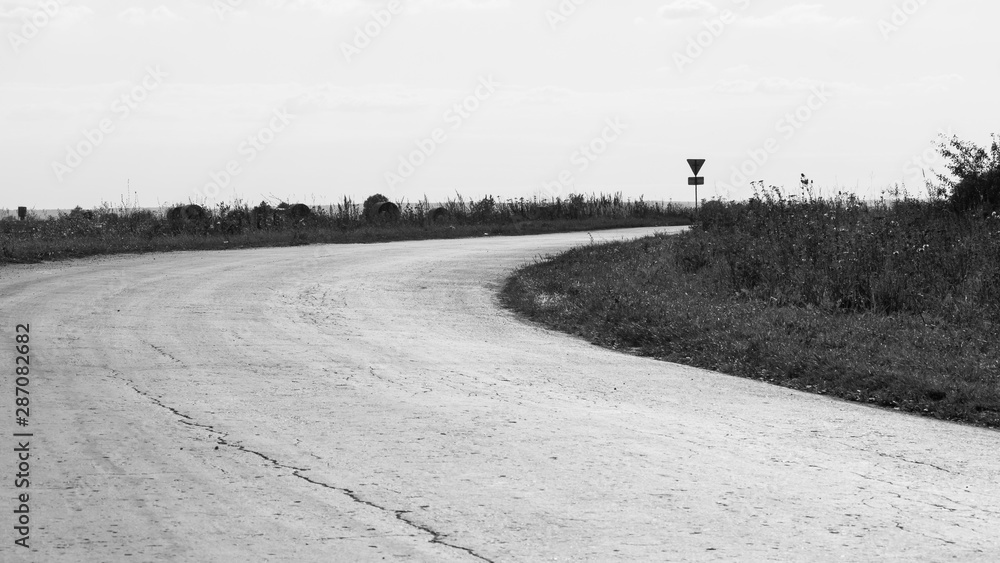 monochrome photography of the road. asphalt road with cracks leading to ...