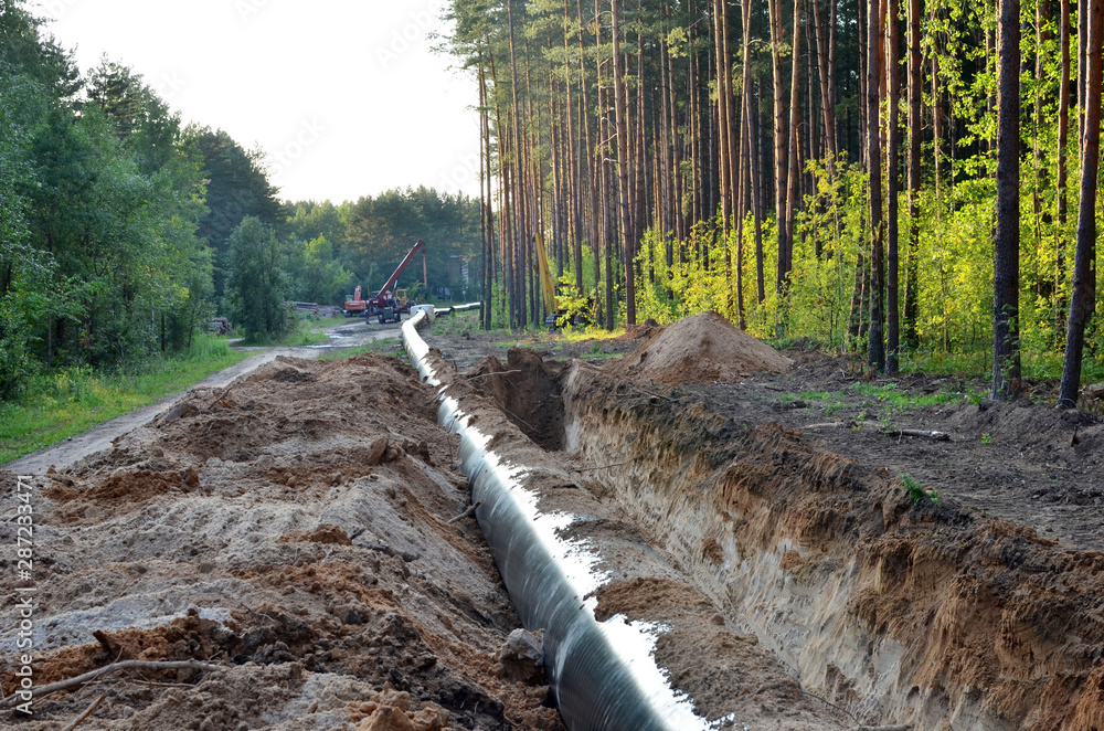 Natural gas pipeline construction work. A dug trench in the ground for ...