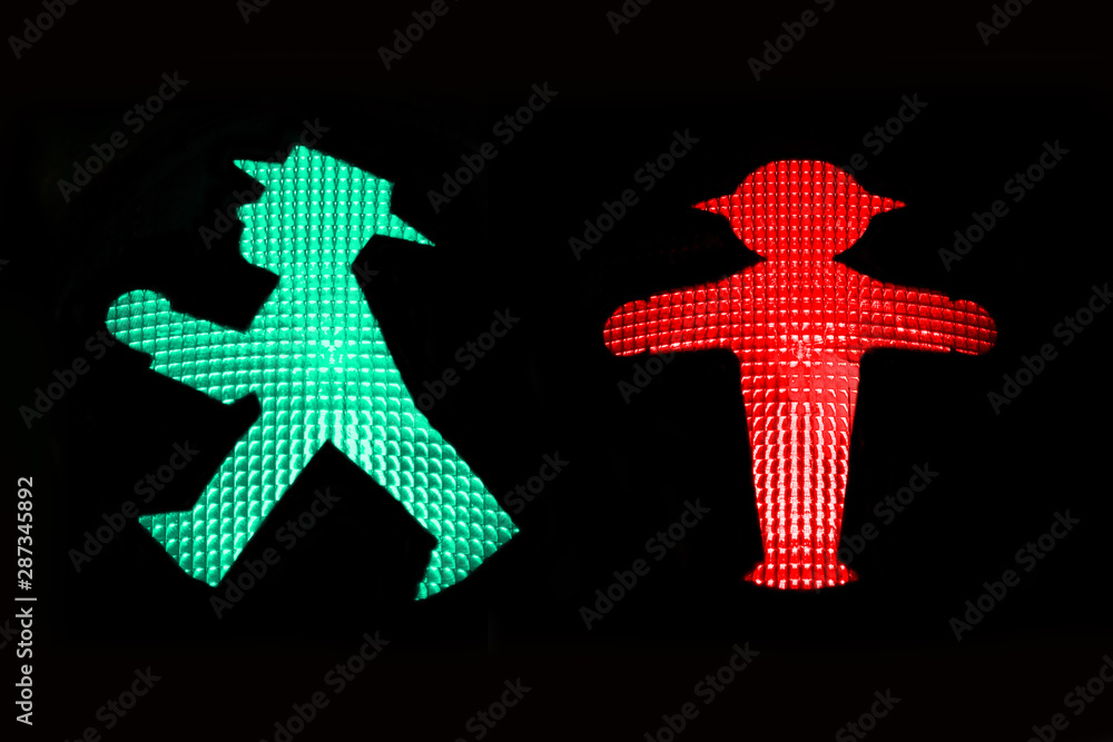 Red and Green pedestrian traffic light with the stop and go icons of ...