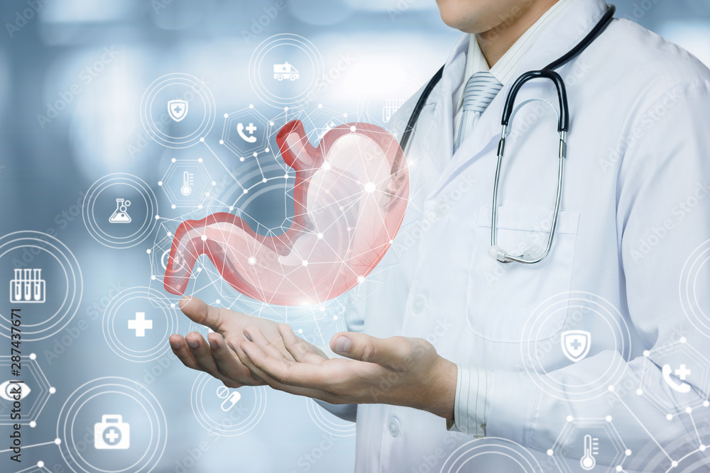 The doctor shows the patient stomach on blurred background. Stock Photo ...