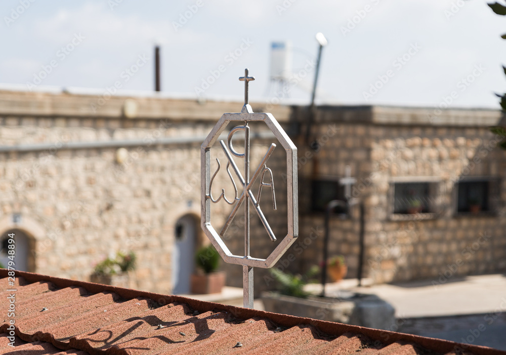 Metallic religious orthodox sign in the courtyard of the Greek Orthodox ...