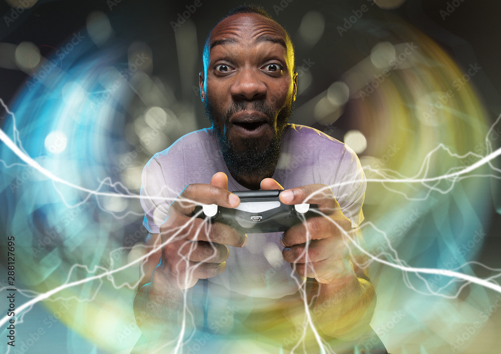 Full immersion in gameplay. Young man holding a video game controller ...