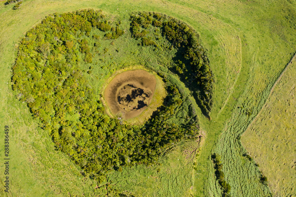 Aerial top view looking into a volcanic caldera crater lake at the ...