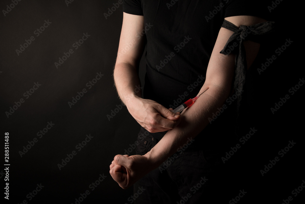 Man injecting with substance in syringe. Drug abuse concept. Sports ...