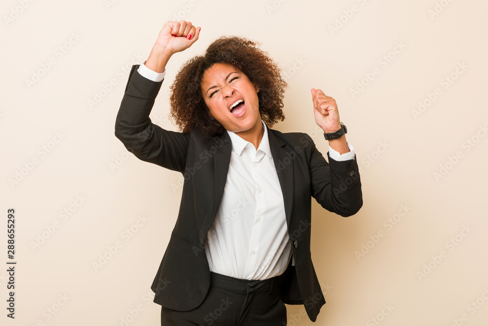 Young business african american woman celebrating a special day, jumps ...