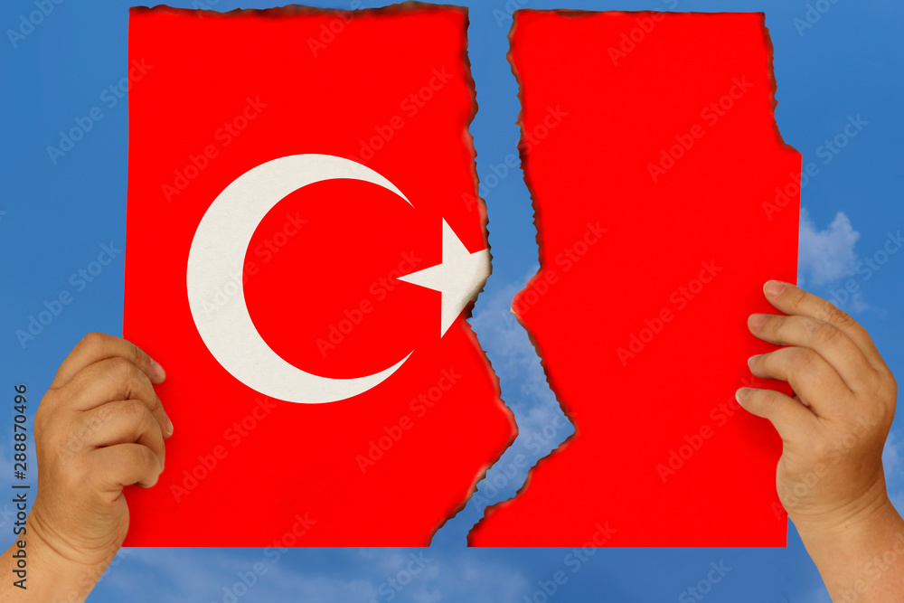 Photo Stock woman holds in both hands against a blue sky torn in two ...