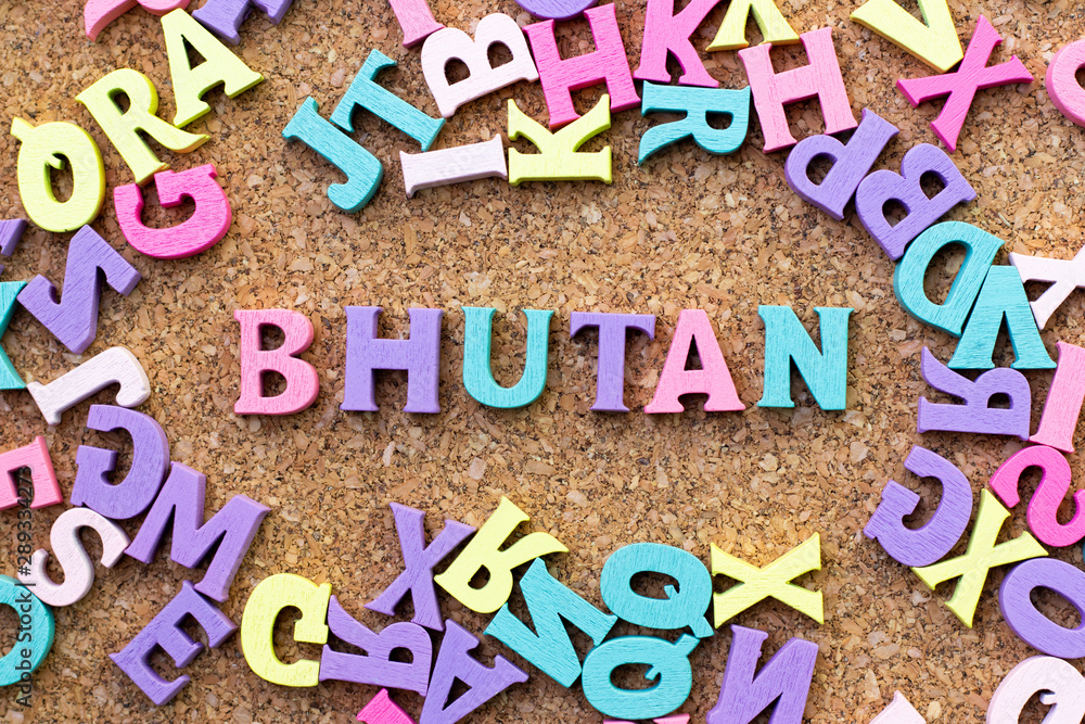 Color alphabet in word Bhutan with another letter as frame on cork ...