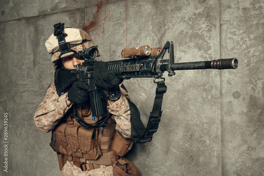 fully equipped army soldier in camo uniform and helmet, armed with ...