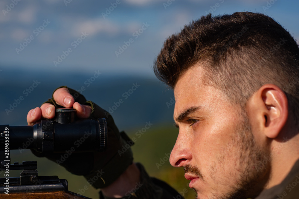 Target with optic sight. Snipers carbine at the outdoor hunting - close ...