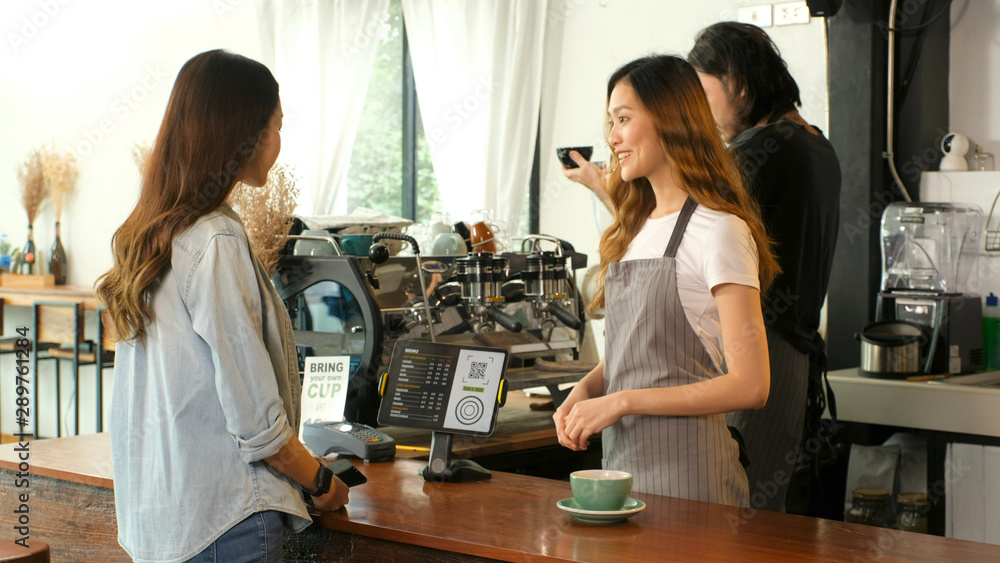 Young asian woman ordering coffee with barista, waitress, small ...