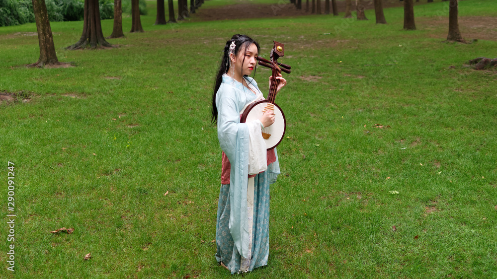 Beautiful Asian woman in cyan costume clothes hanfu holding yueqin ...
