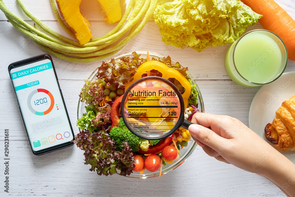 nutritional information concept. hand use the magnifying glass to zoom ...