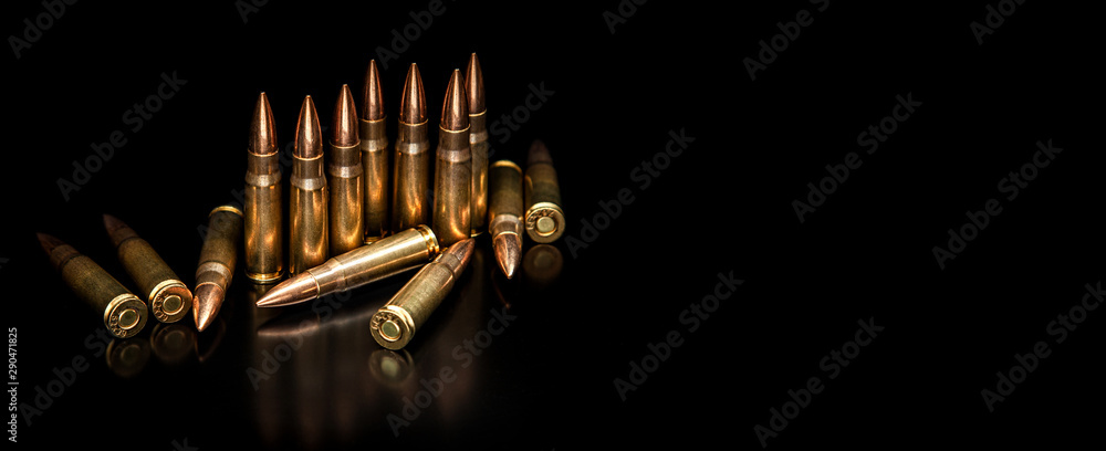 Bullet isolated on black background with reflexion. Rifle bullets close ...