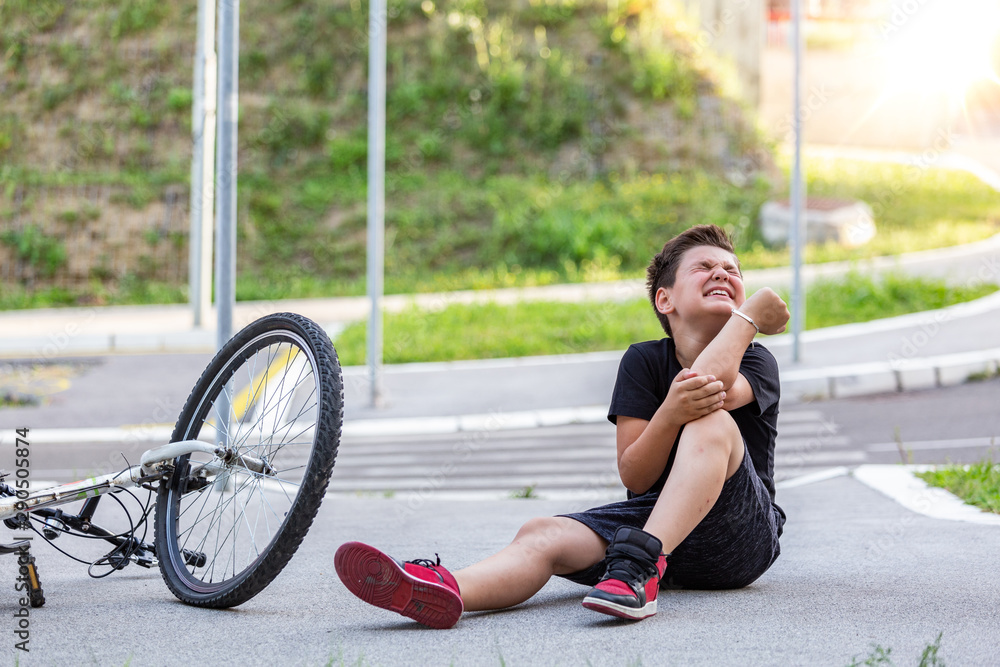 Teenage boy There is a elbow injury, as the bike falls while riding ...