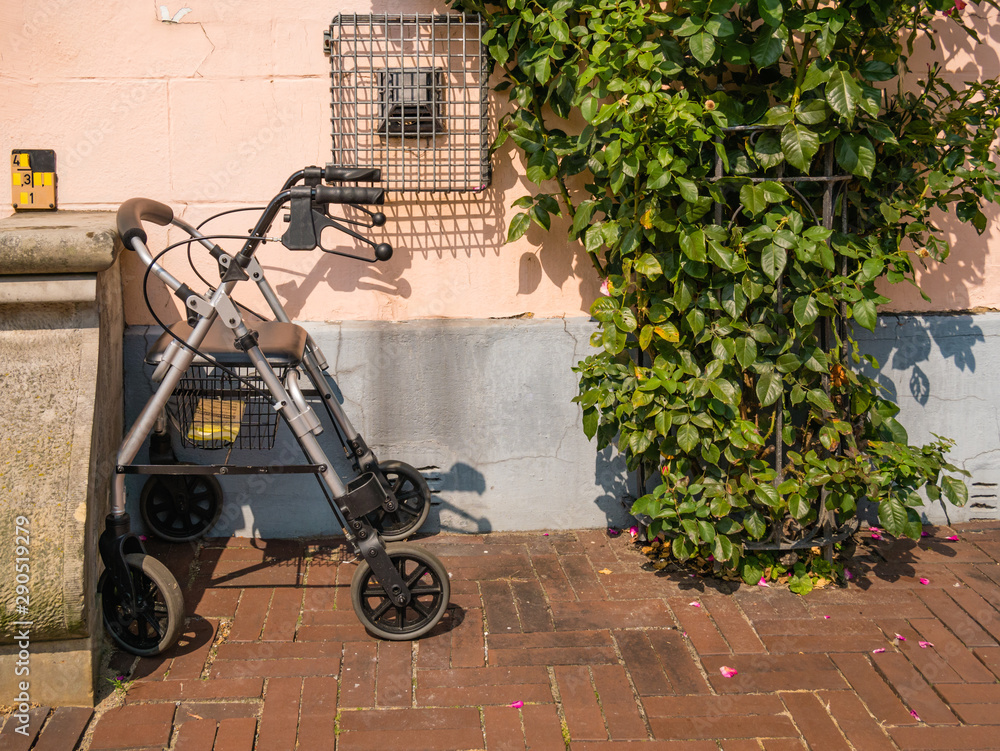 Rollator Walker with signs of use in front of a house at sunny day ...