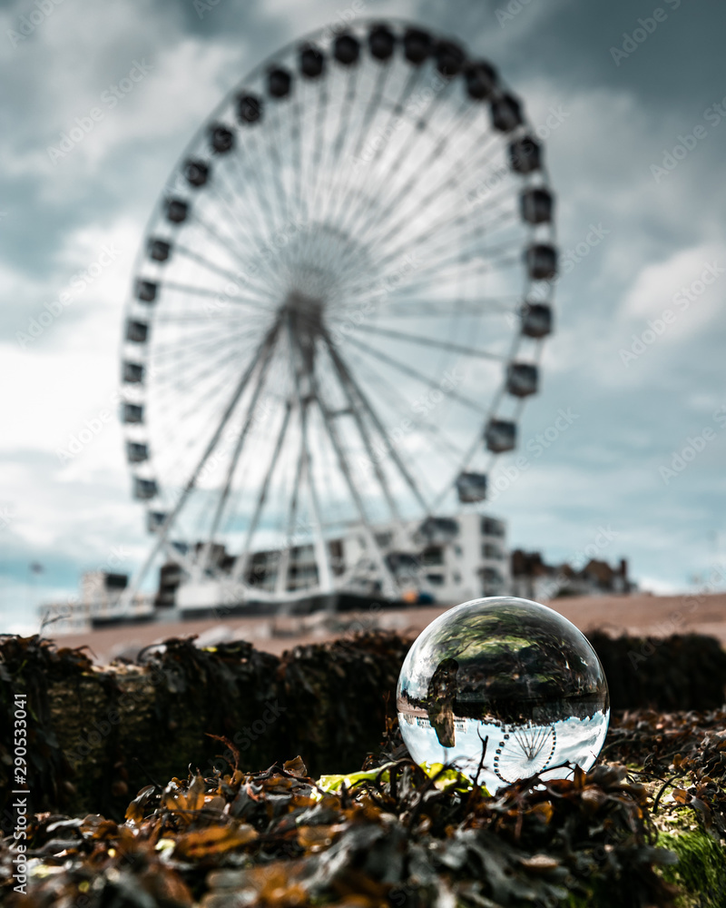 ferris wheel and crystal ball on the beach Stock Photo | Adobe Stock