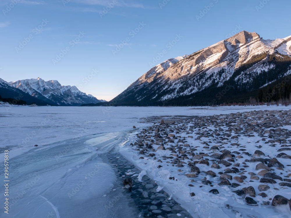 Sunset on a frozen lake in Kananaskis Country in the Canadian Rocky ...