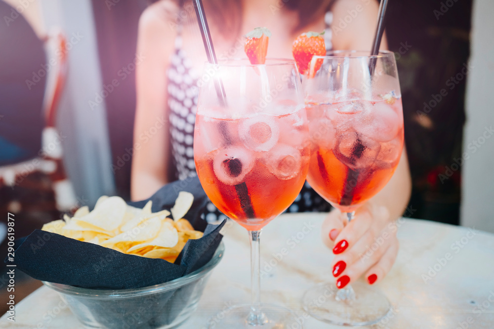 Girl with iced alcohol drinks. Glass of sparkling Spritz cocktails with ...