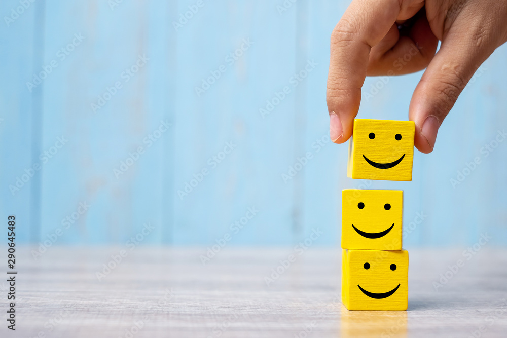 smile face on yellow wood cube. Service rating, ranking, customer ...