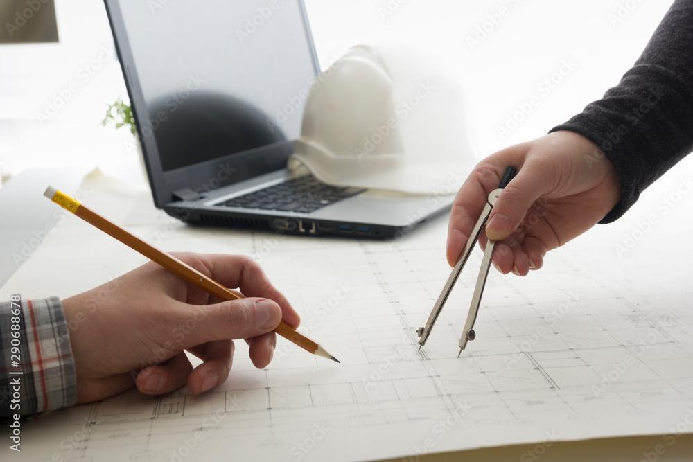 Architects working on blueprint, real estate project. Architect ...