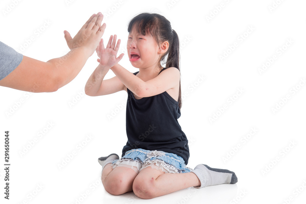 Sad asian girl crying while her mother punish her over white background ...