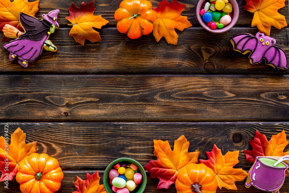 Nice halloween background with sweets. Cookies and pumpkins on dark wooden top view frame copy ...