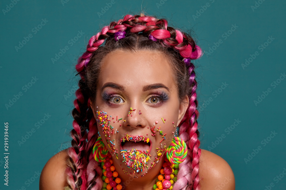 Lovely girl with a multi-colored braids hairstyle and bright make-up ...
