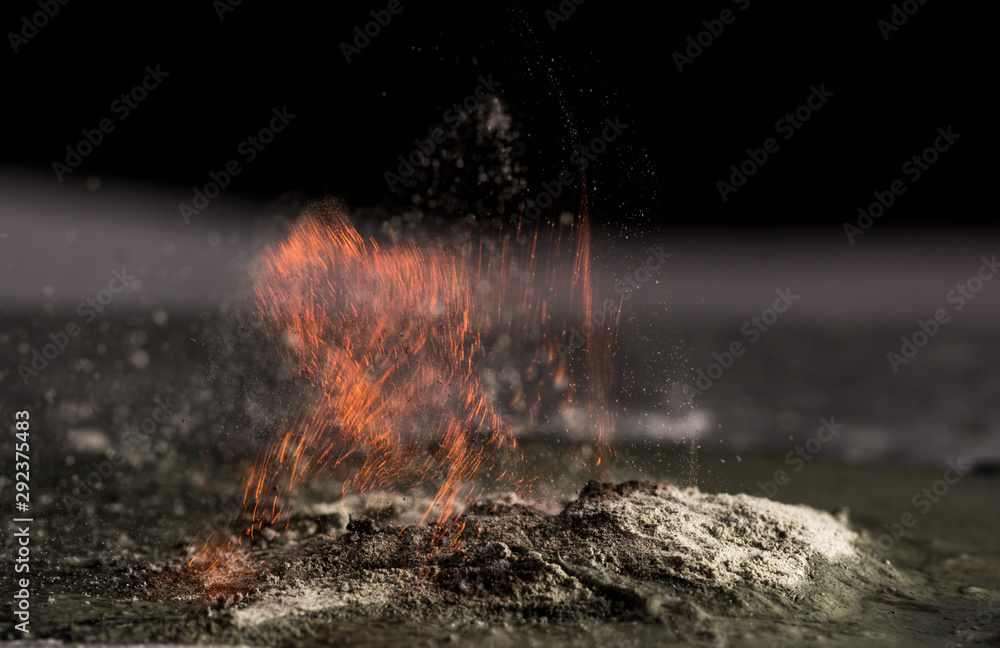 burning sand and a splash of water on a black background, the fifth ...