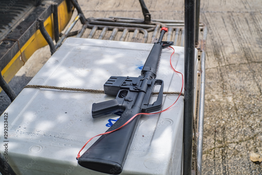 One Black Gun toy for Children with the Plastic rope bind on the gun ...